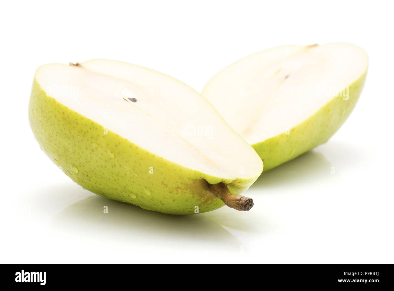 Two green pear halves isolated on white background Stock Photo - Alamy