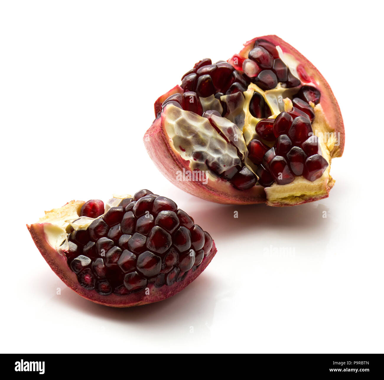 Pomegranate isolated on white background two split open parts with ...