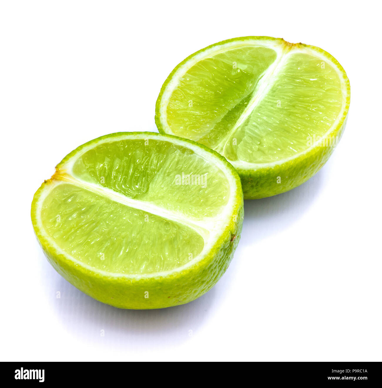 Two lime halves, sliced, isolated on white studio background Stock ...