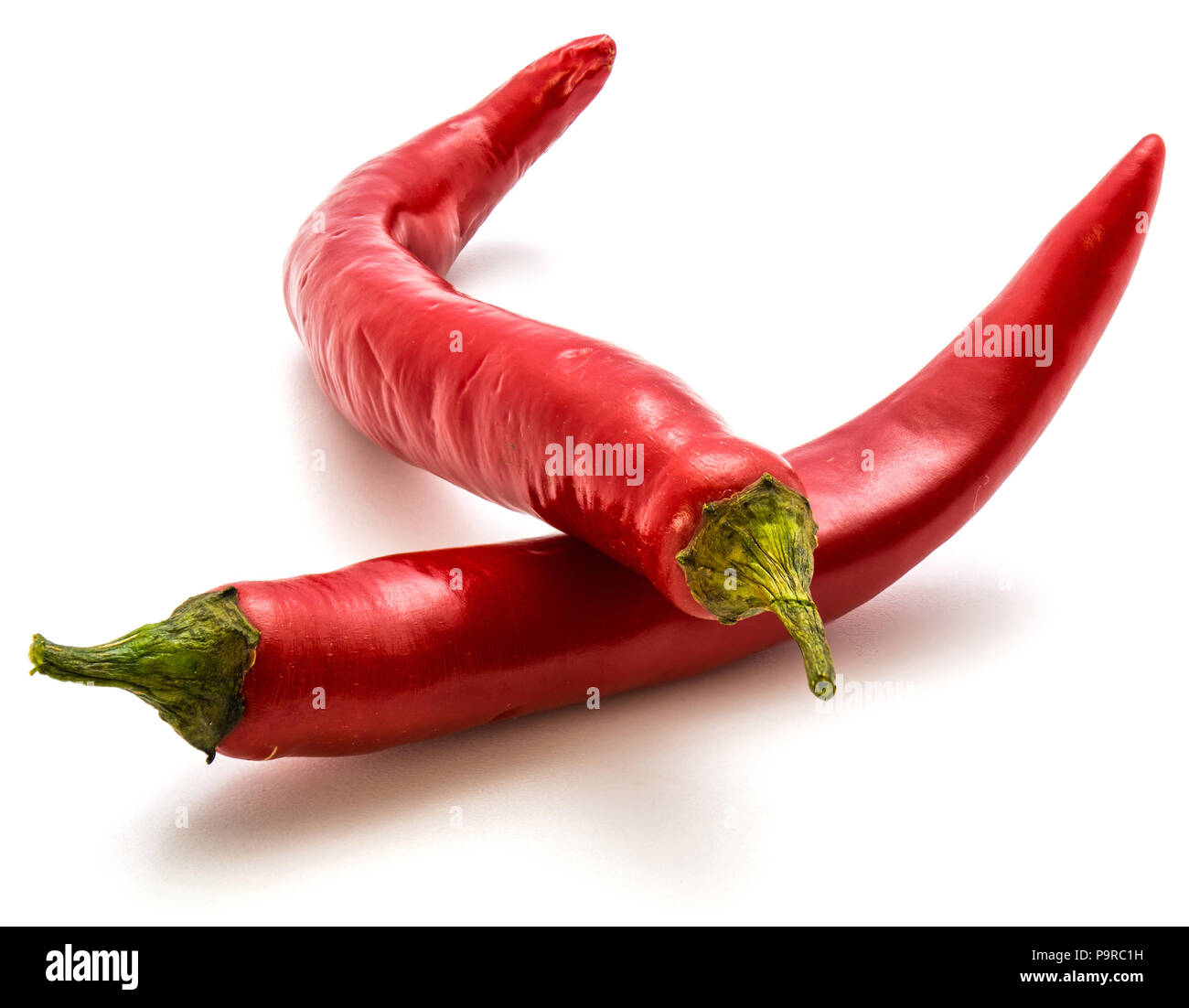 Two red Chili peppers isolated on white background Stock Photo - Alamy