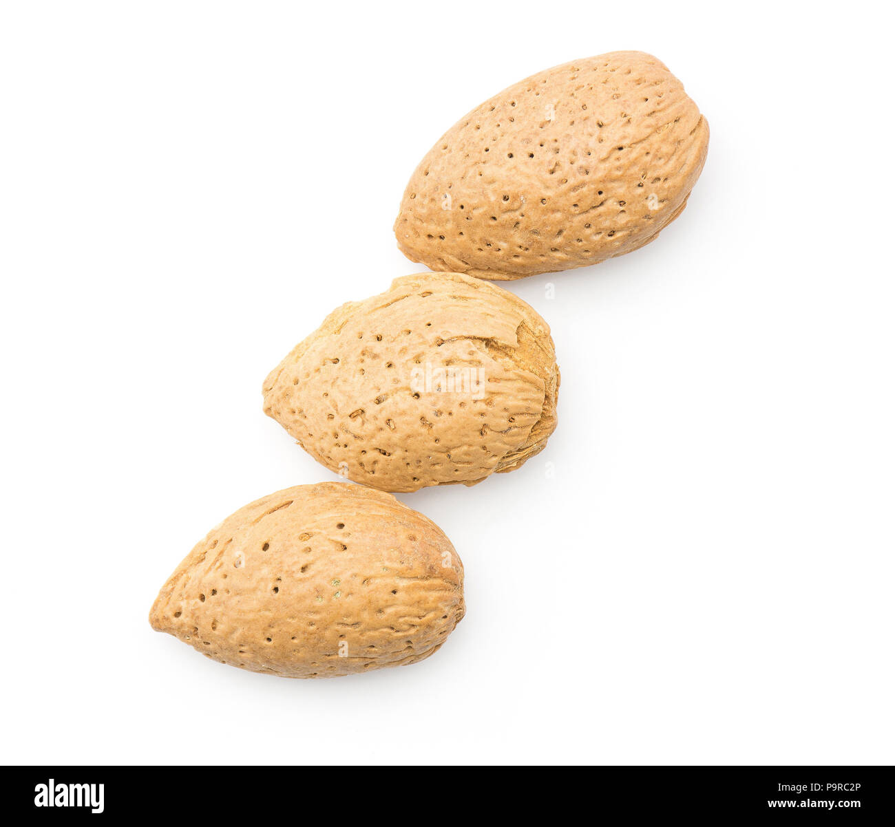 Three almonds top view isolated on white background unshelled nuts ...