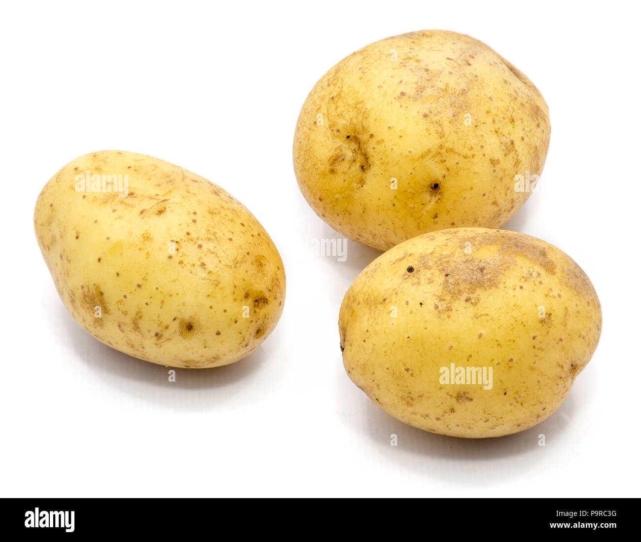 Three whole potatoes isolated on white background Stock Photo - Alamy