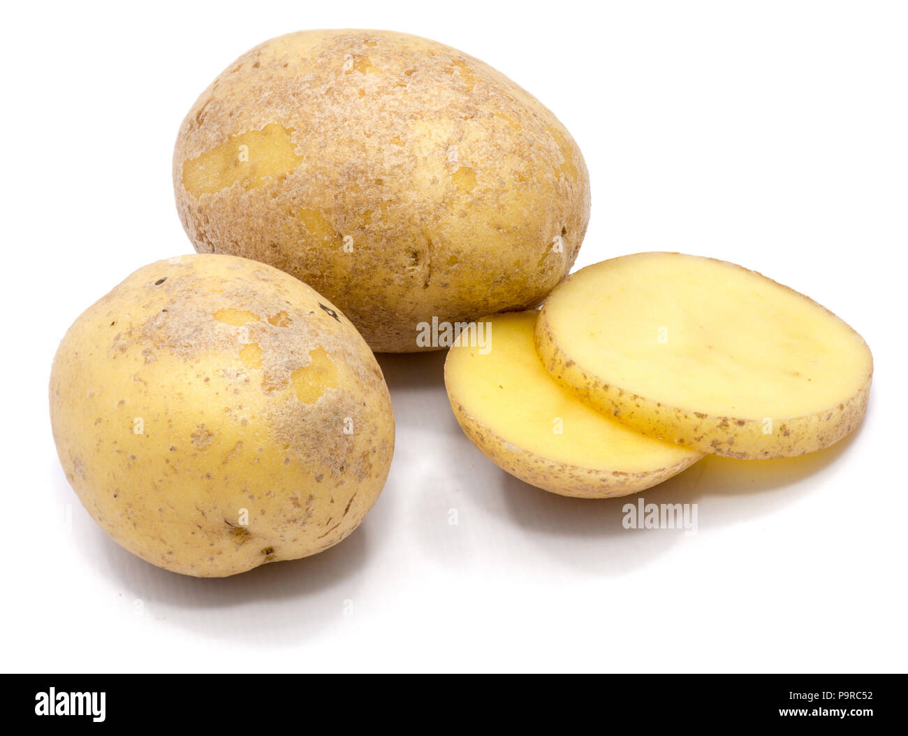Two whole potatoes and two slices isolated on white background Stock ...