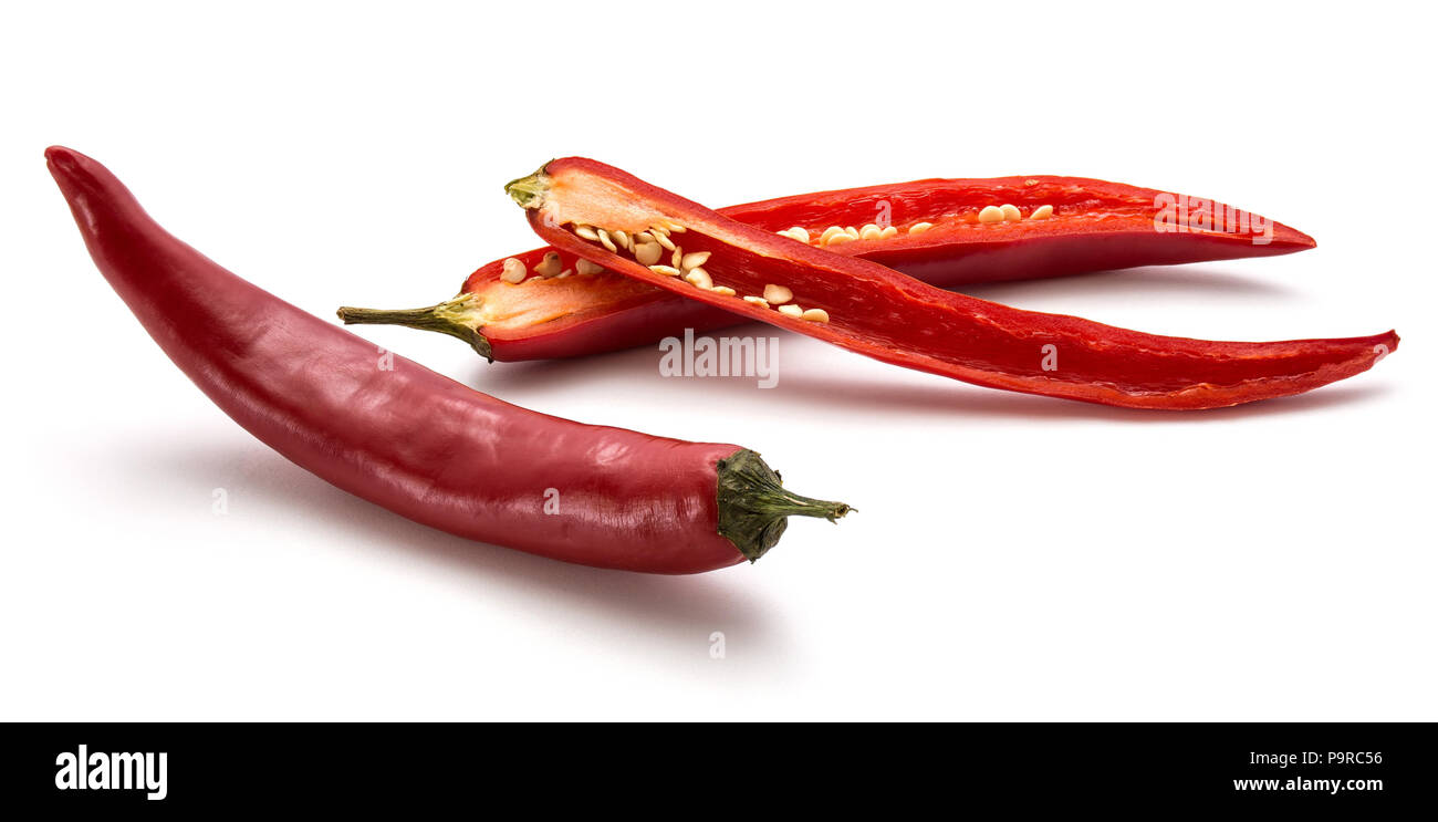One whole red Chili pepper and two halves isolated on white background ...