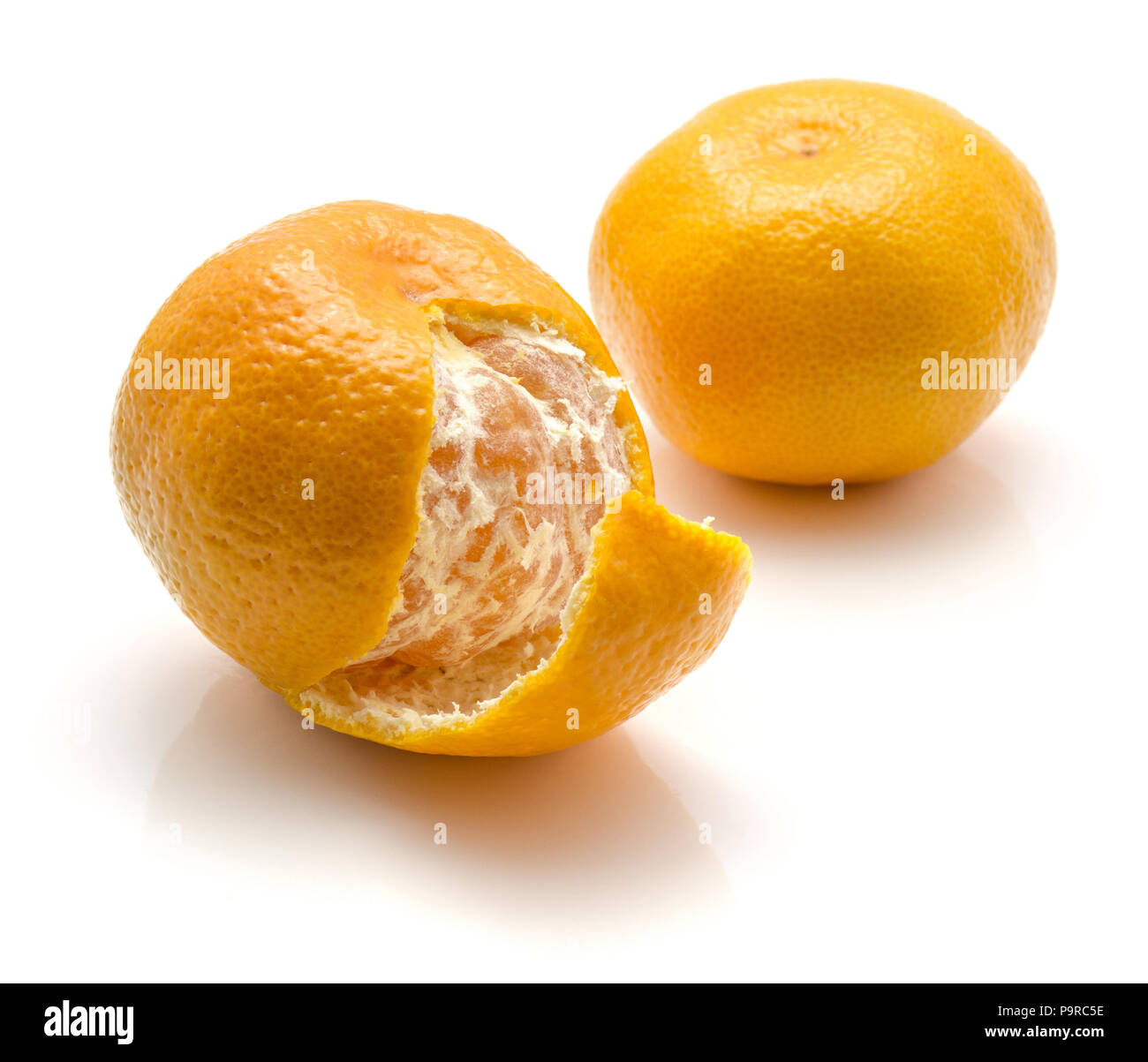 Two tangerines isolated on white background one whole and open Stock ...