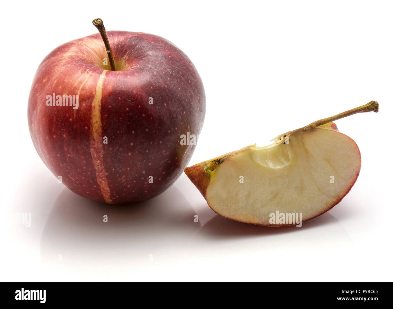 One whole Gala apple and a sliced quarter with a stem isolated on white ...