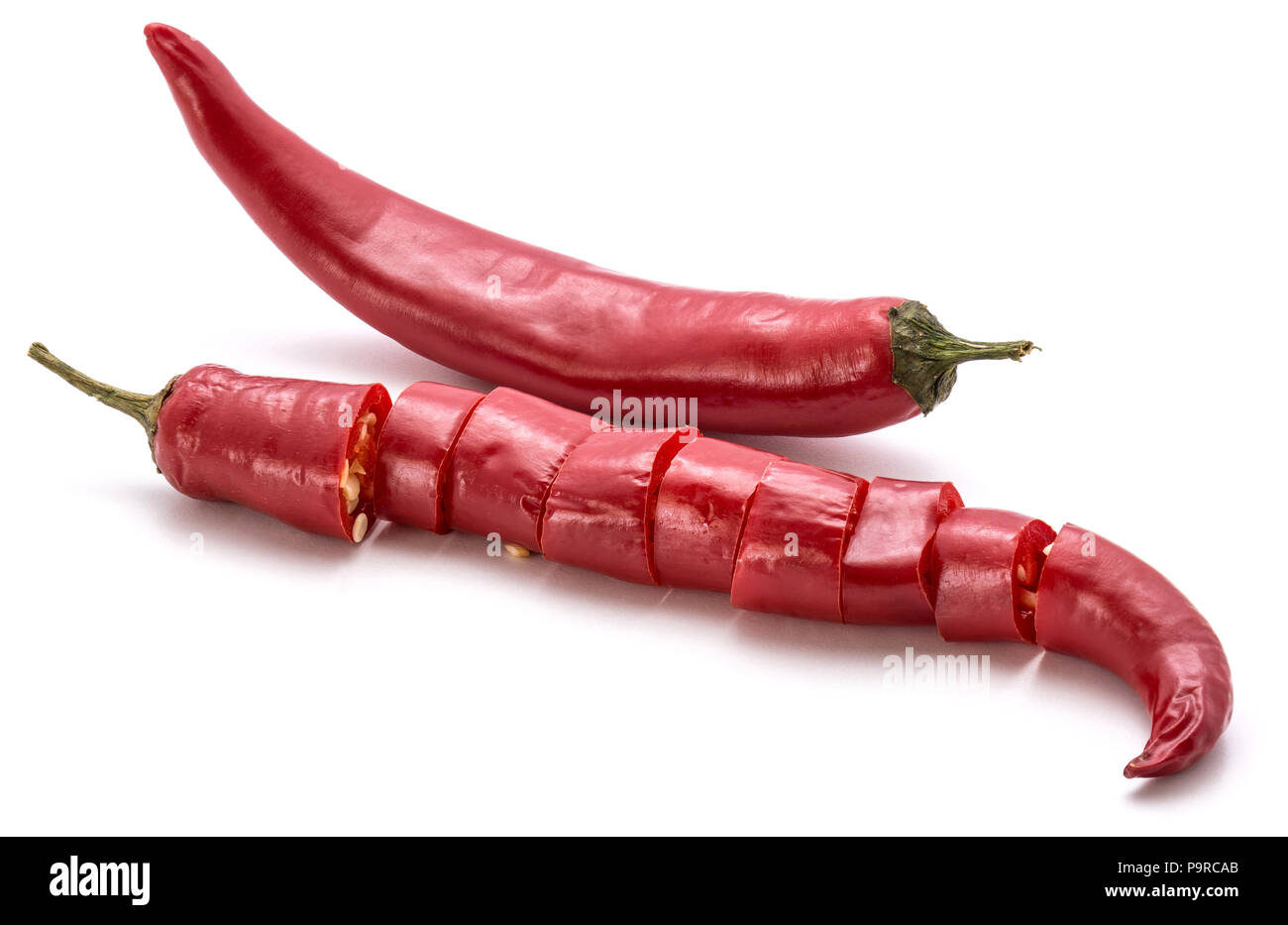 One whole and sliced red Chili pepper isolated on white background ...