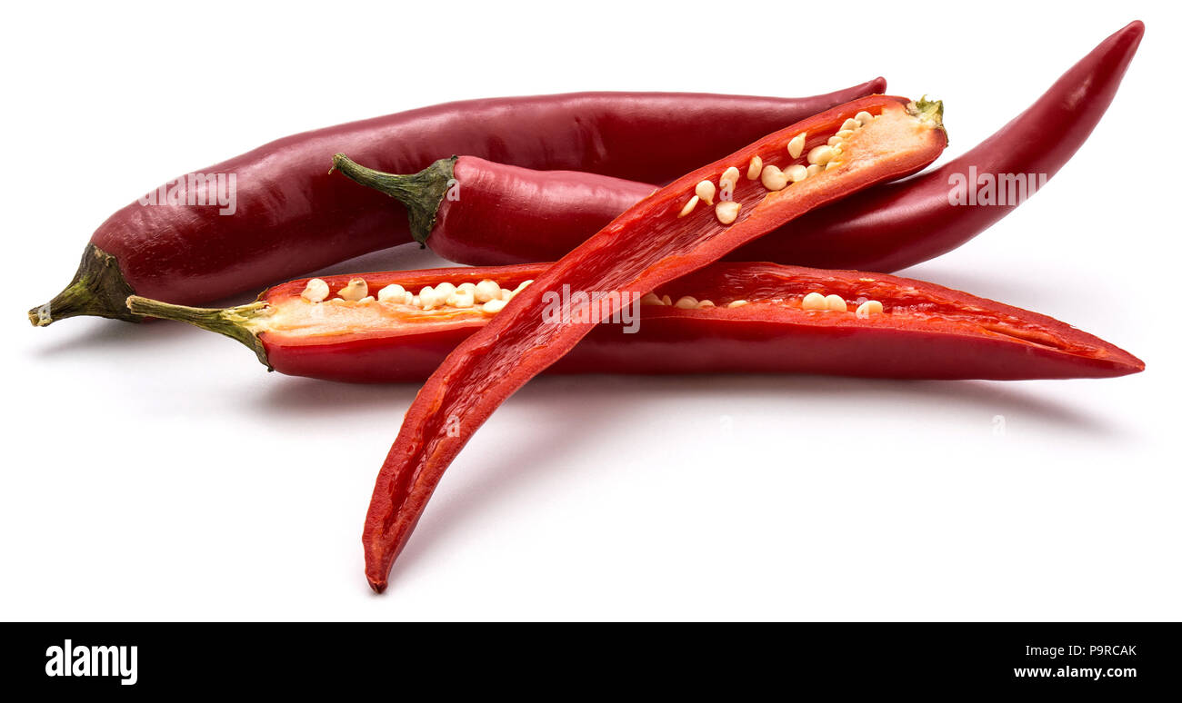 Two whole red Chili peppers and two halves isolated on white background ...