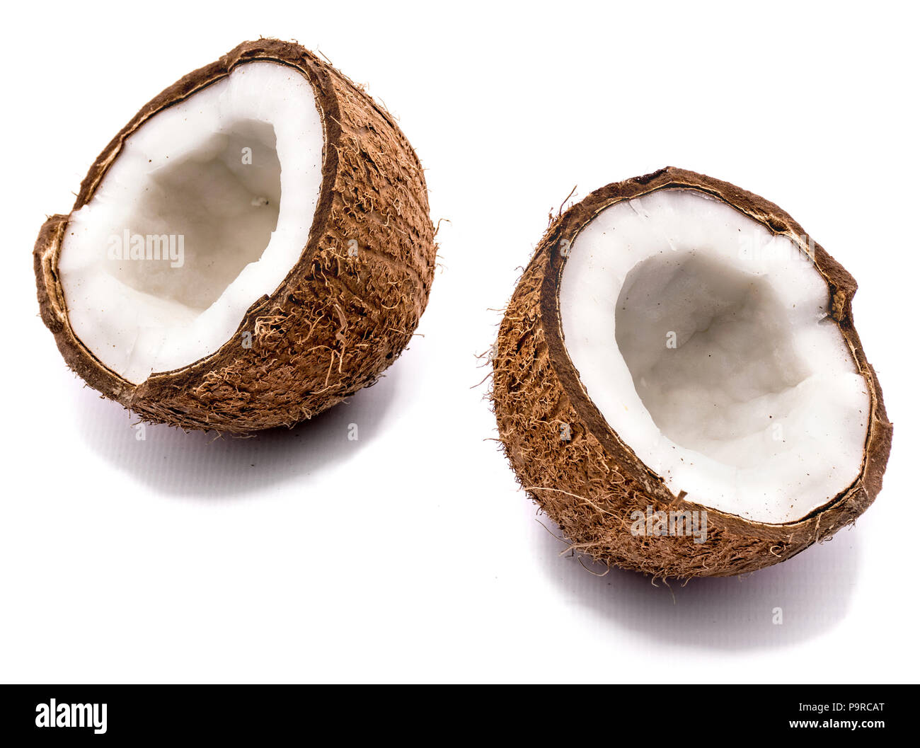 Two cracked coconut halves isolated on white background Stock Photo - Alamy