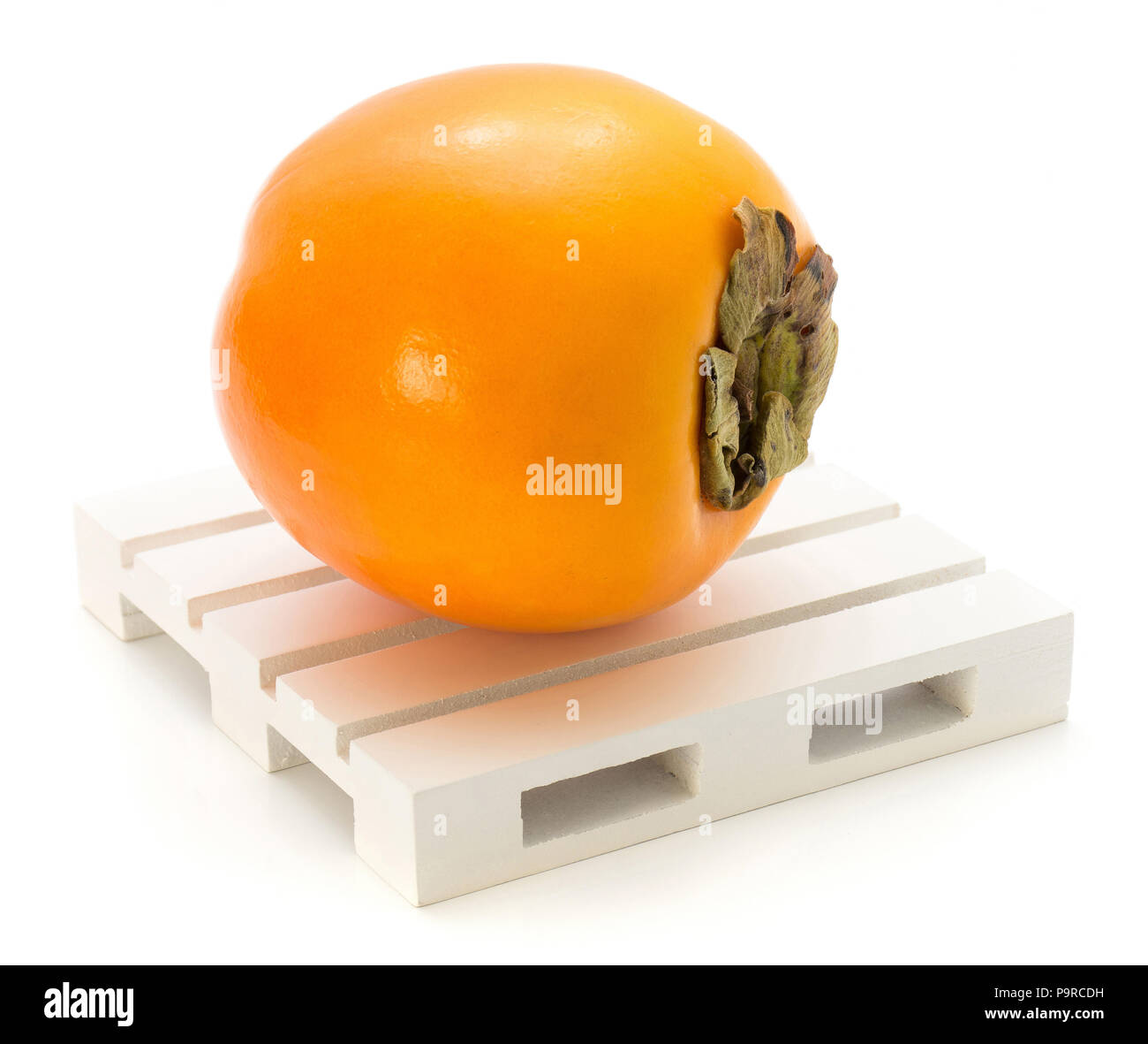 Persimmon Kaki on a pallet isolated on white background Stock Photo - Alamy