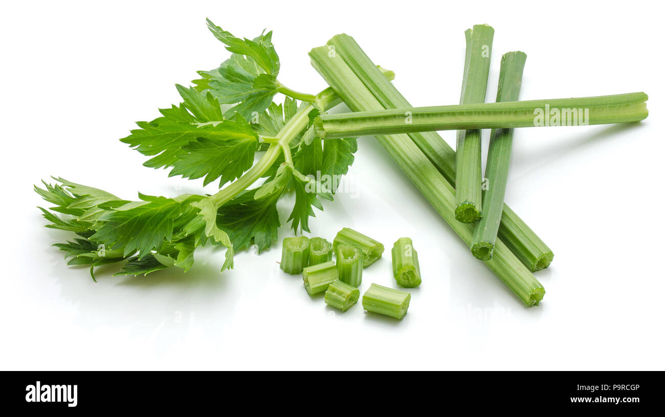 Sliced fresh celery pieces, sticks and leaves, isolated on white ...