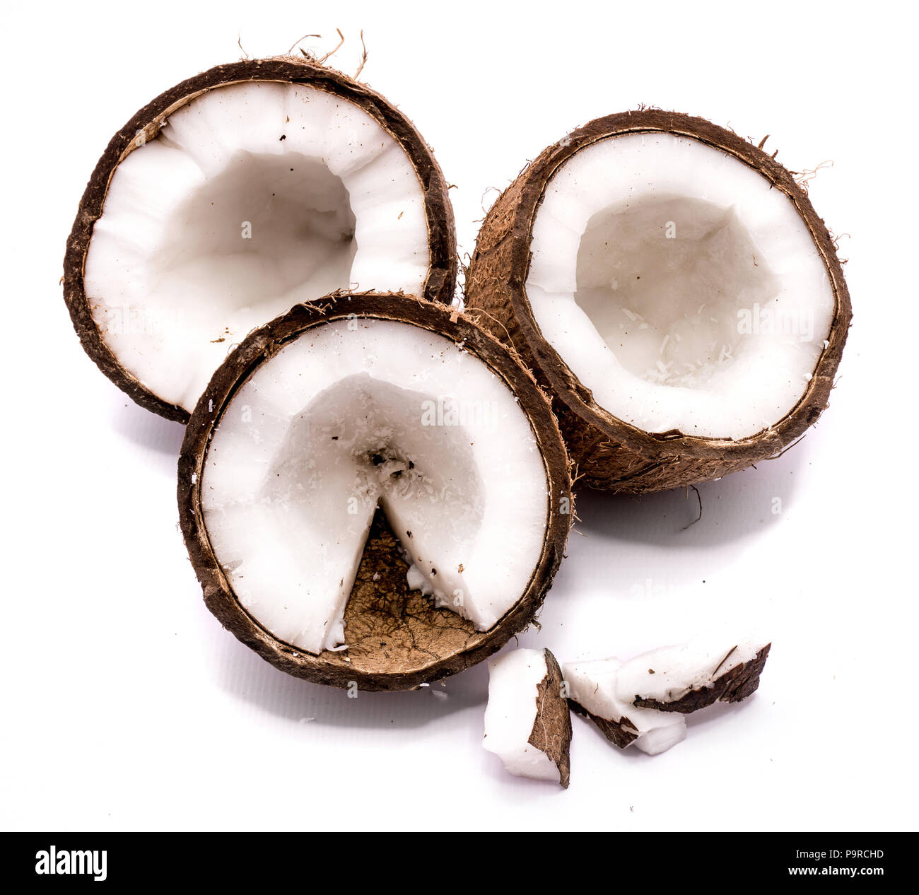 Three coconut halves and meat pieces isolated on white background Stock ...