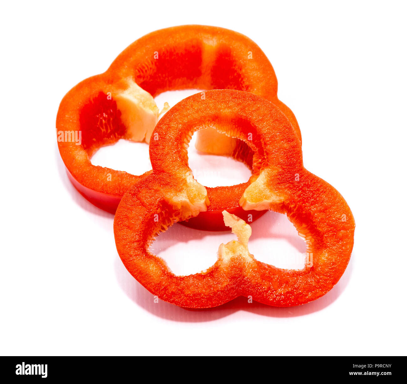 Red sliced pieces of pepper isolated on white background Stock Photo ...