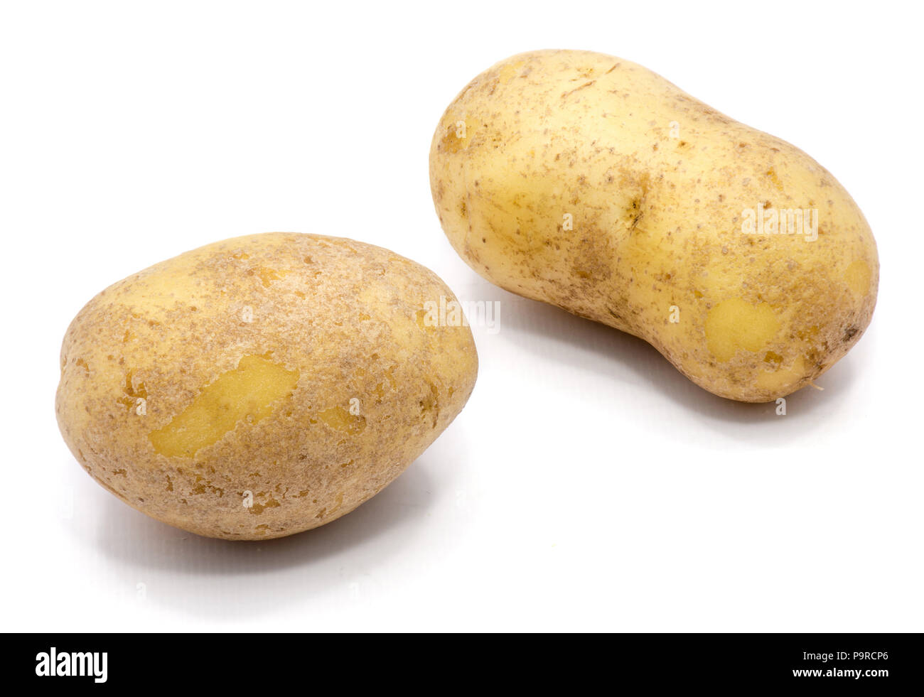 Two whole potatoes isolated on white background Stock Photo - Alamy