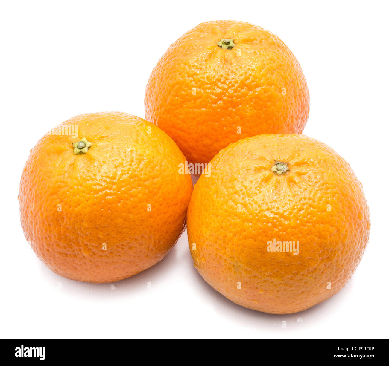 Three whole orange Clementines with water drops isolated on white ...