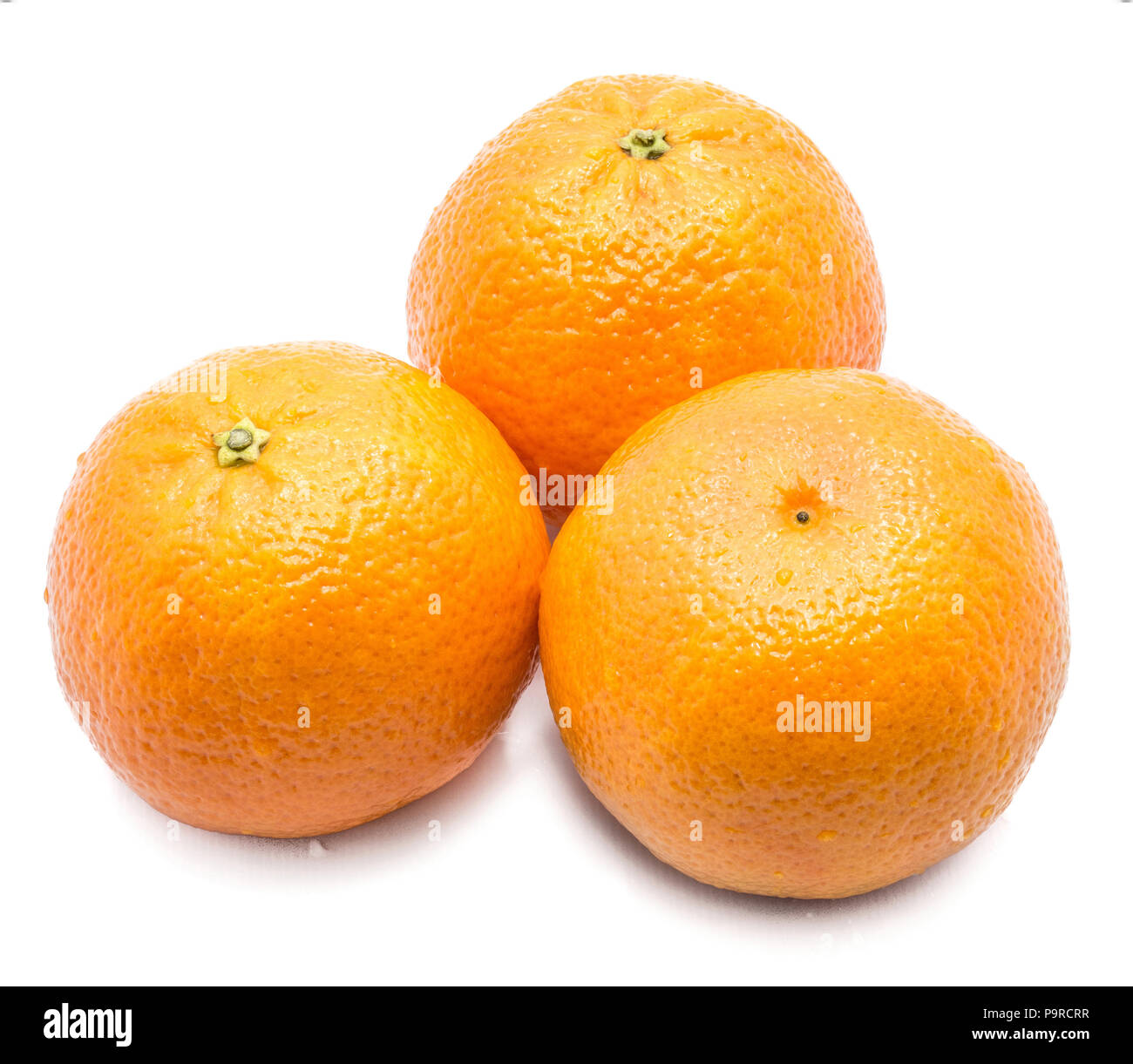 Three whole orange Clementines with water drops isolated on white ...