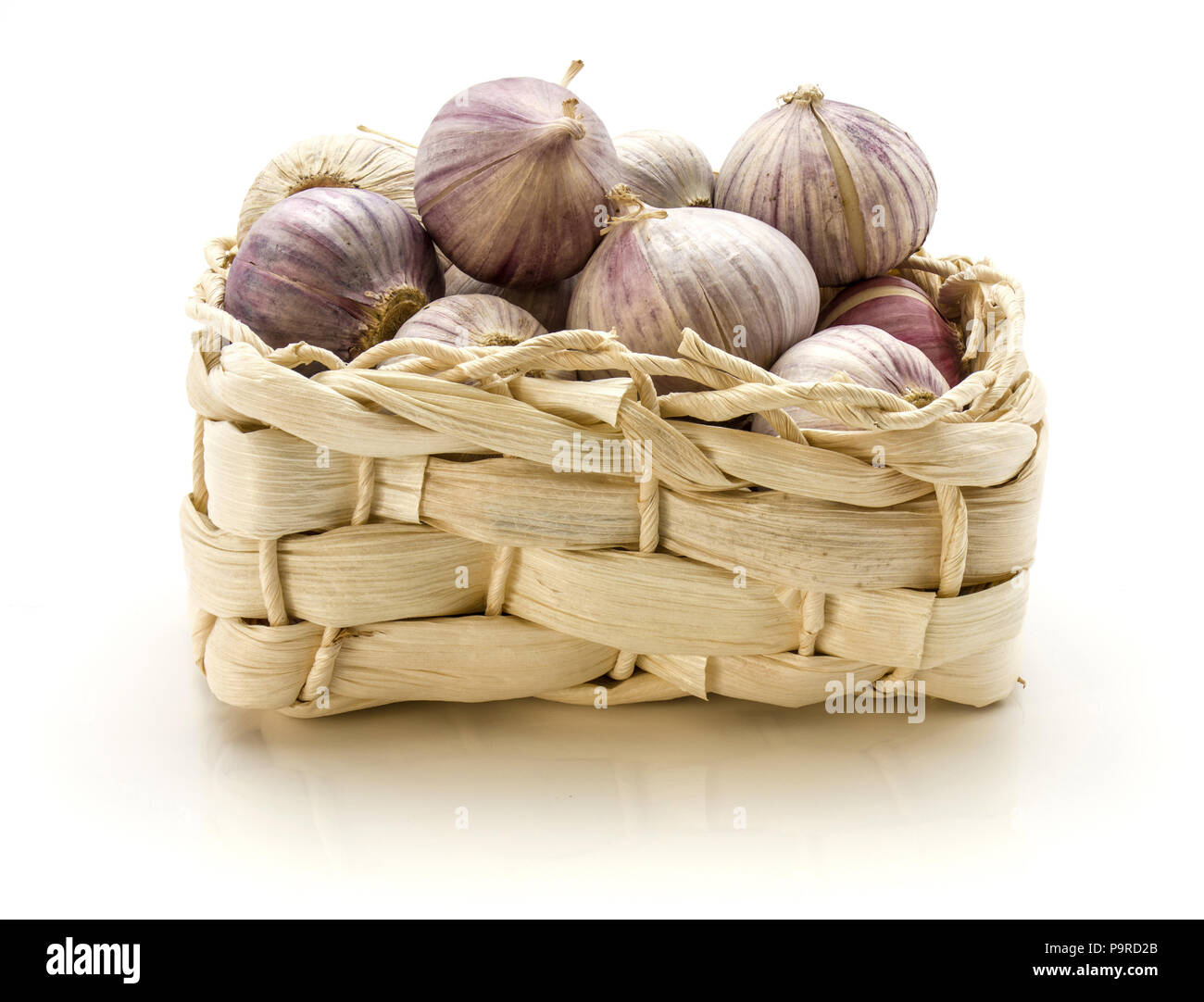Full straw basket of solo garlic isolated on white background Stock ...