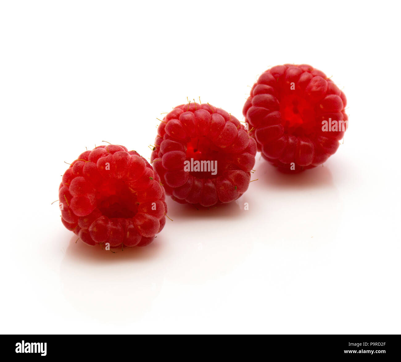 Three red raspberries isolated on white background in row Stock Photo ...