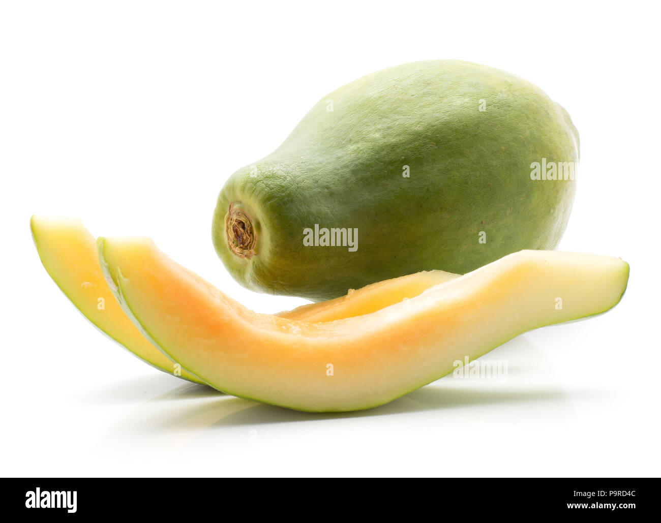 Green papaya (pawpaw, papaw) one whole and two slices without seeds ...