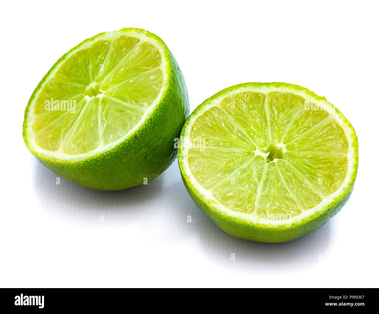 Two cross section lime halves isolated on white background Stock Photo ...
