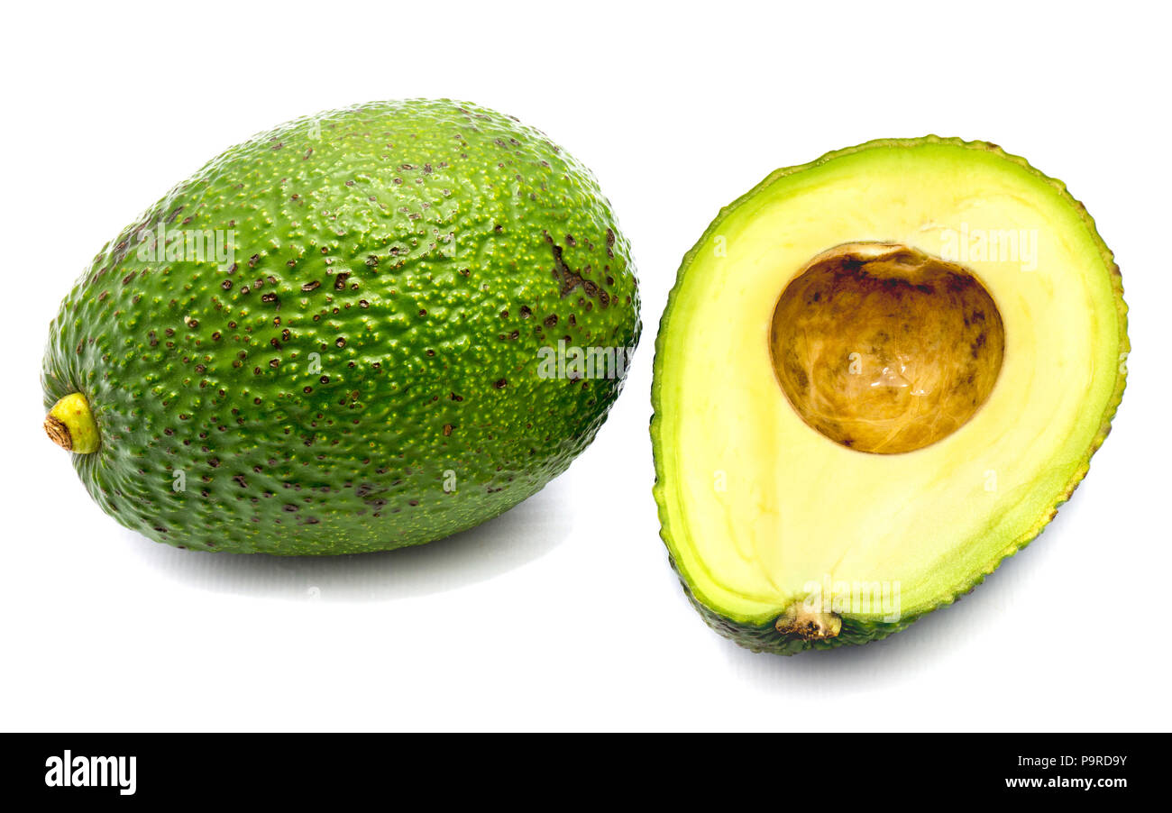 Whole avocado (Persea americana, alligator pear) and its half with a ...