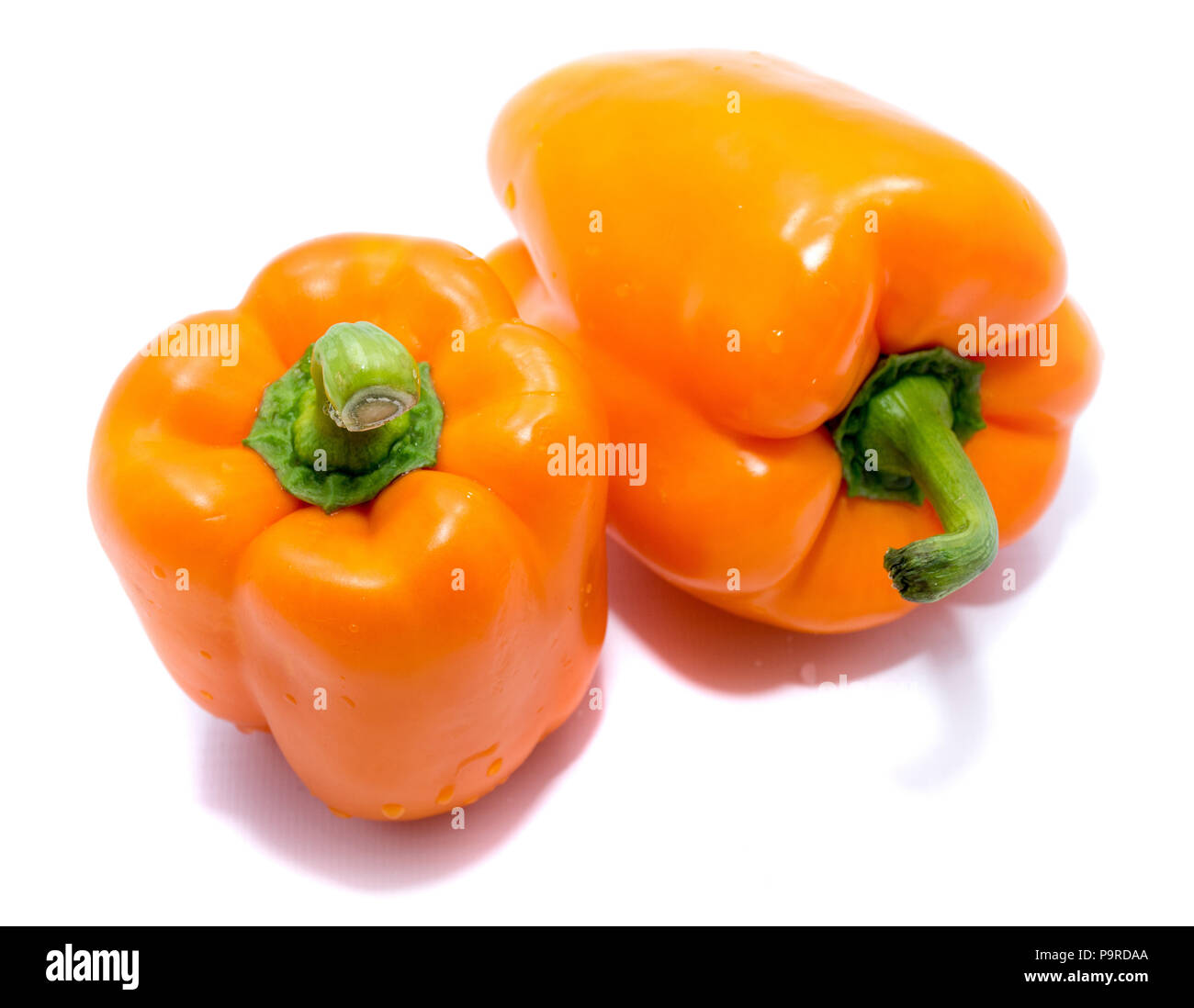Group of orange peppers, one pepper on back, isolated on white ...