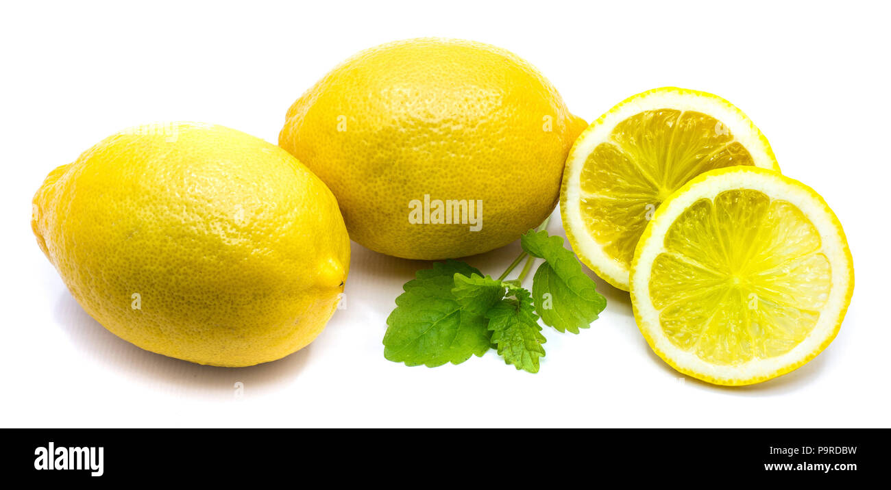 Two whole yellow lemons, cross section, slice and fresh green lemon ...