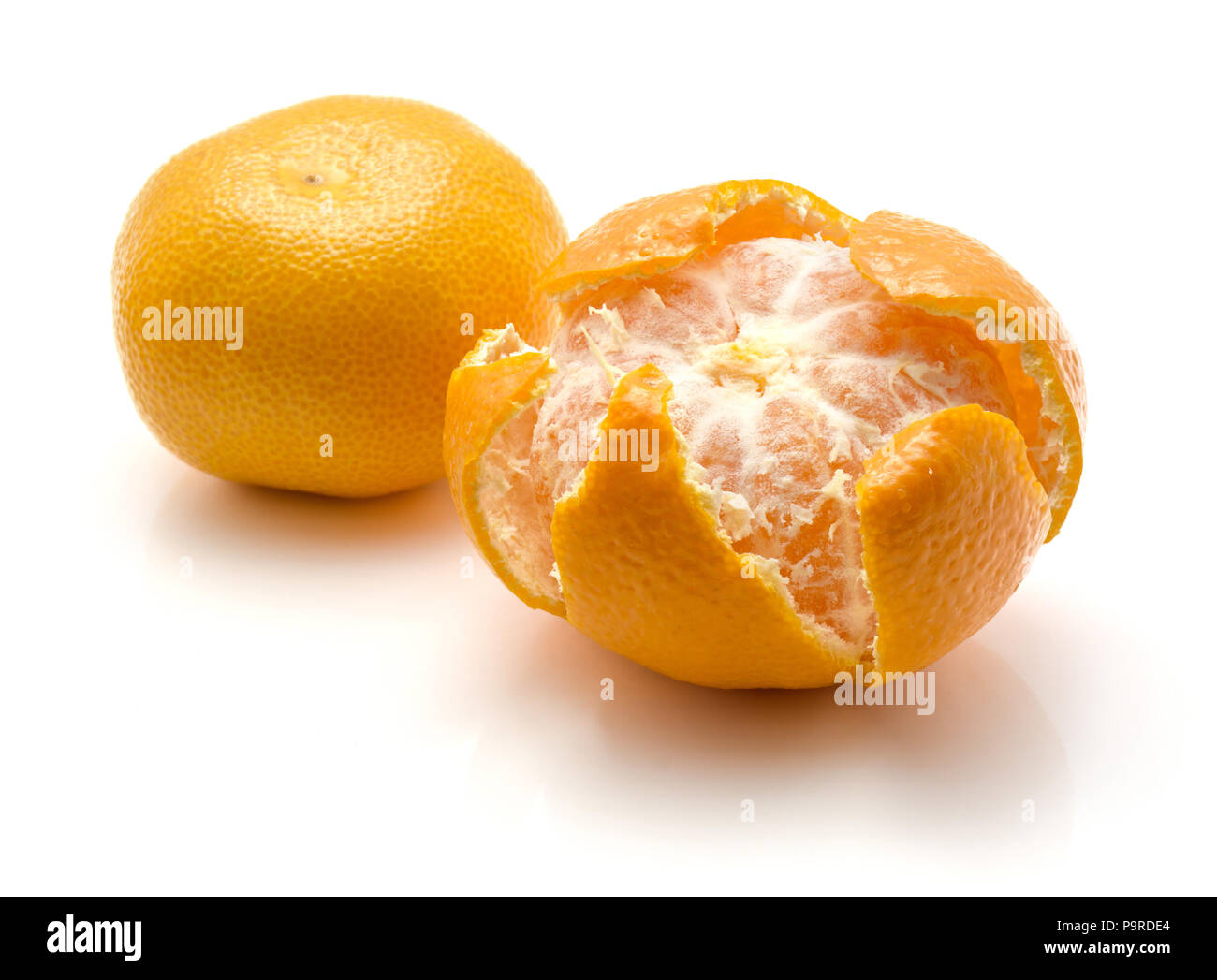 Two tangerines isolated on white background one whole one open Stock ...