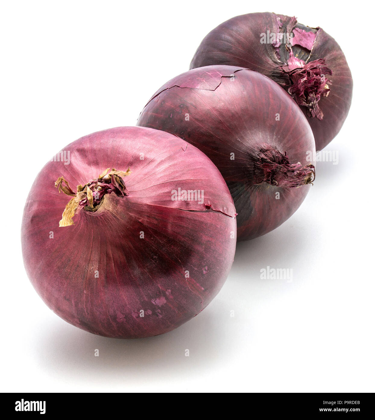Three red onion isolated on white background Stock Photo - Alamy