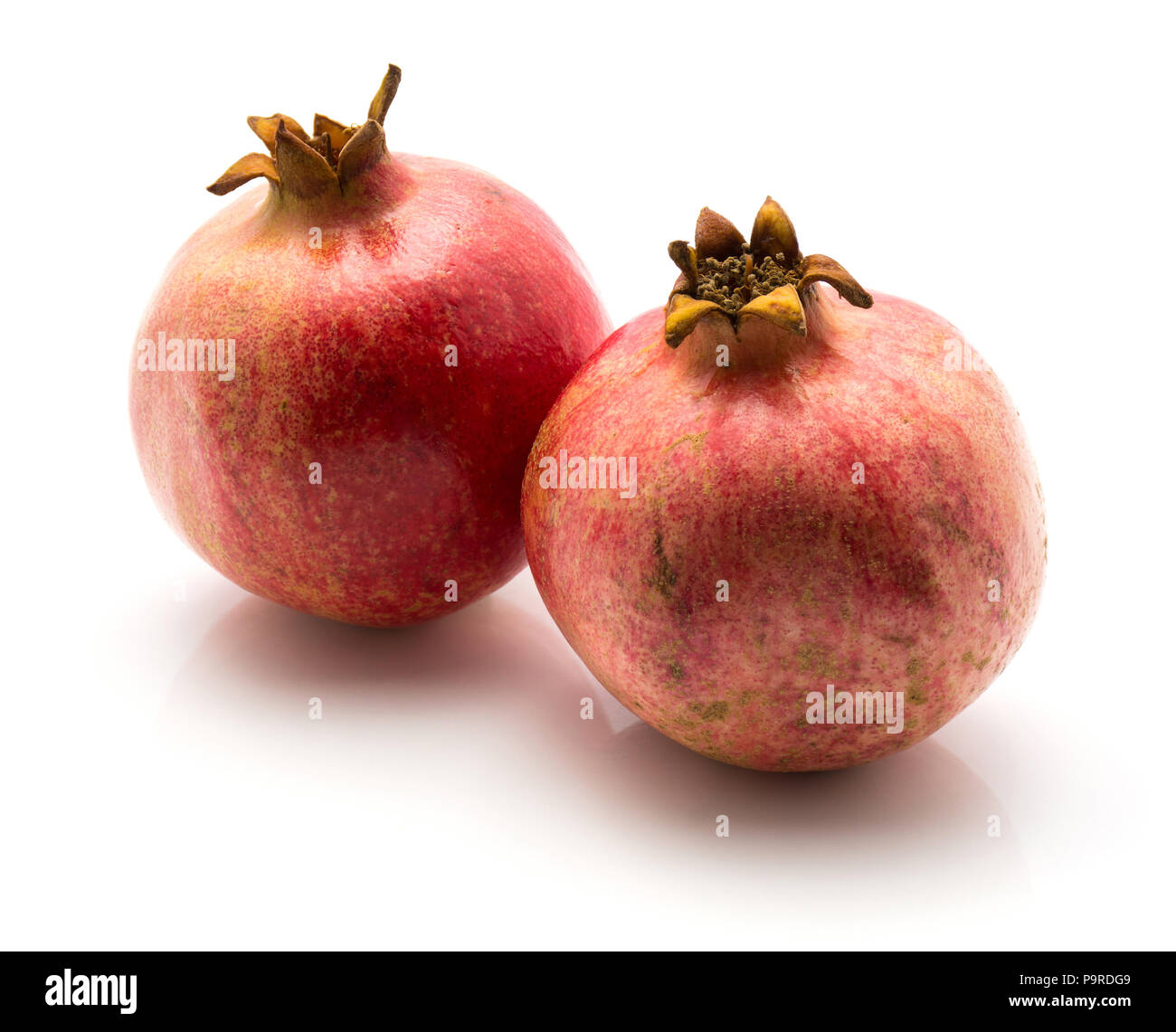 Two pomegranate isolated on white background Stock Photo - Alamy