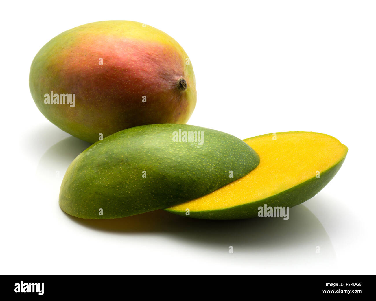 Sliced mango isolated on white background one whole and cut in half ...