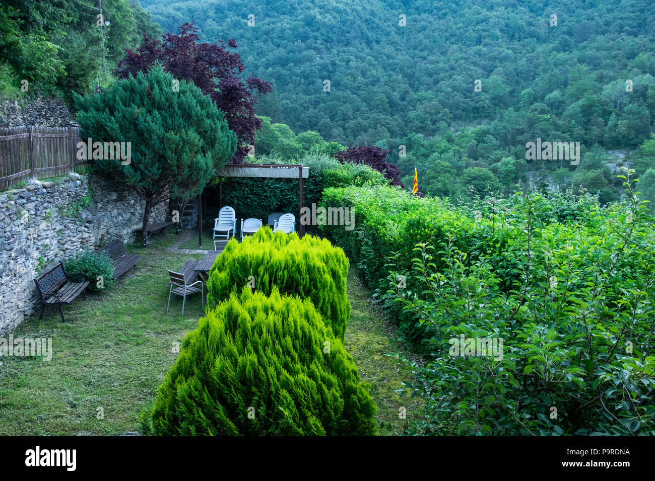 Garden and forested valley behind Hostal El Forn in Beget, Pyrenees ...