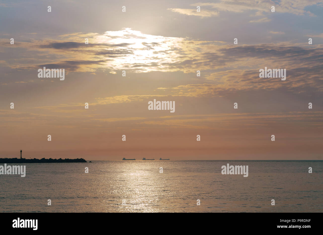 Sunset over the sea. Reflection of sunlight in the sea waves. Red sky ...