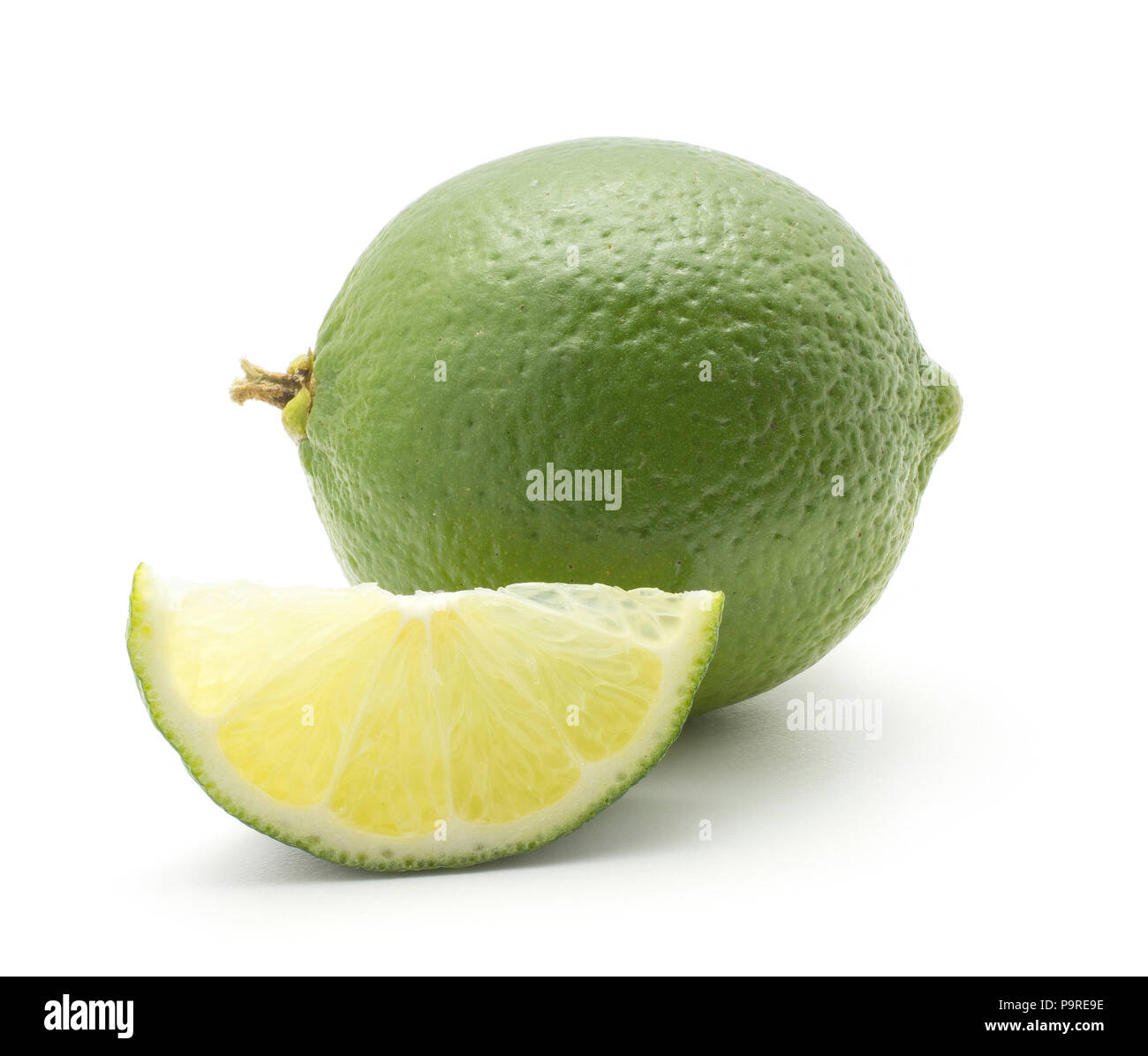 One lime and one slice isolated on white background Stock Photo - Alamy