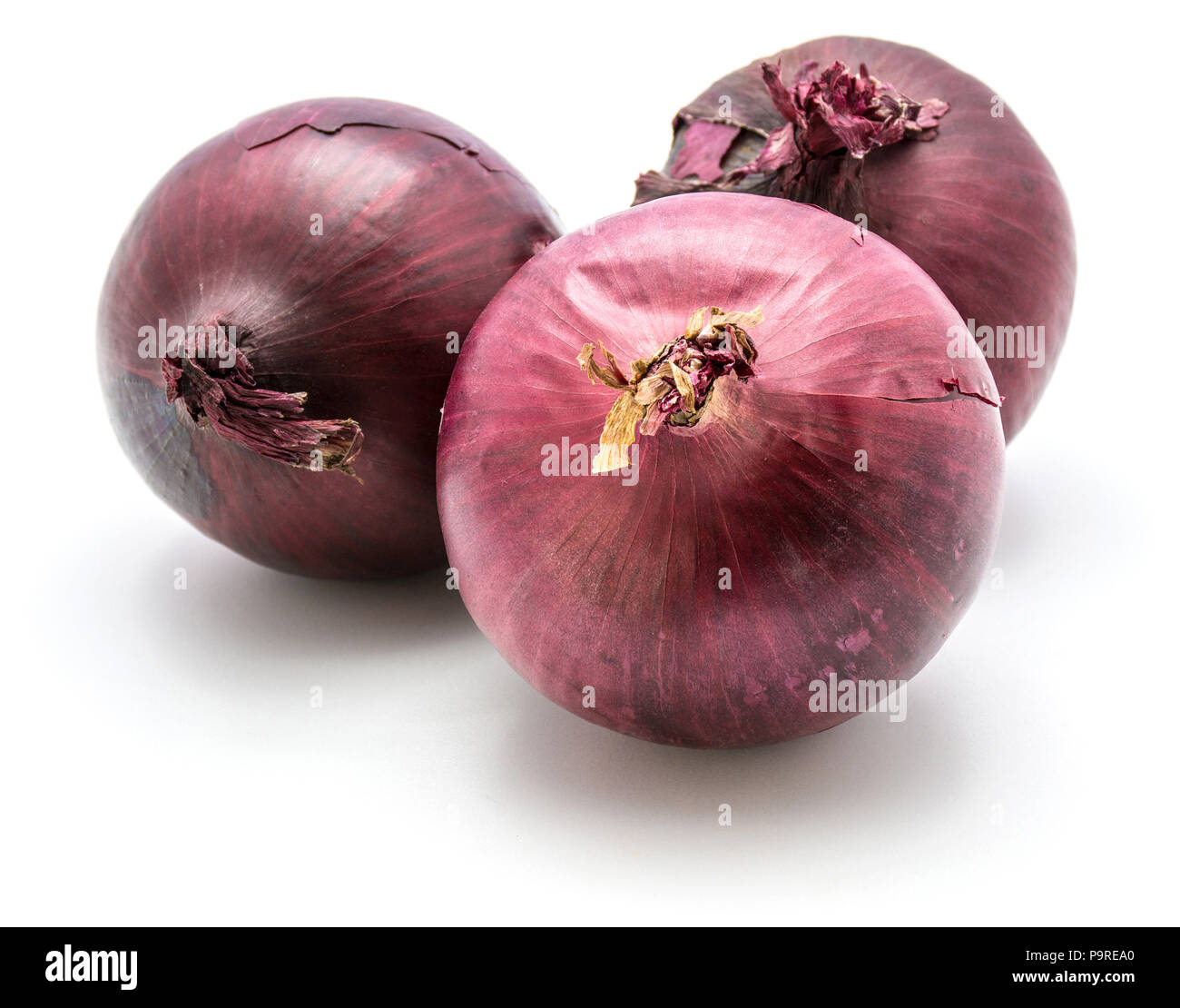 Three red onion isolated on white background Stock Photo - Alamy