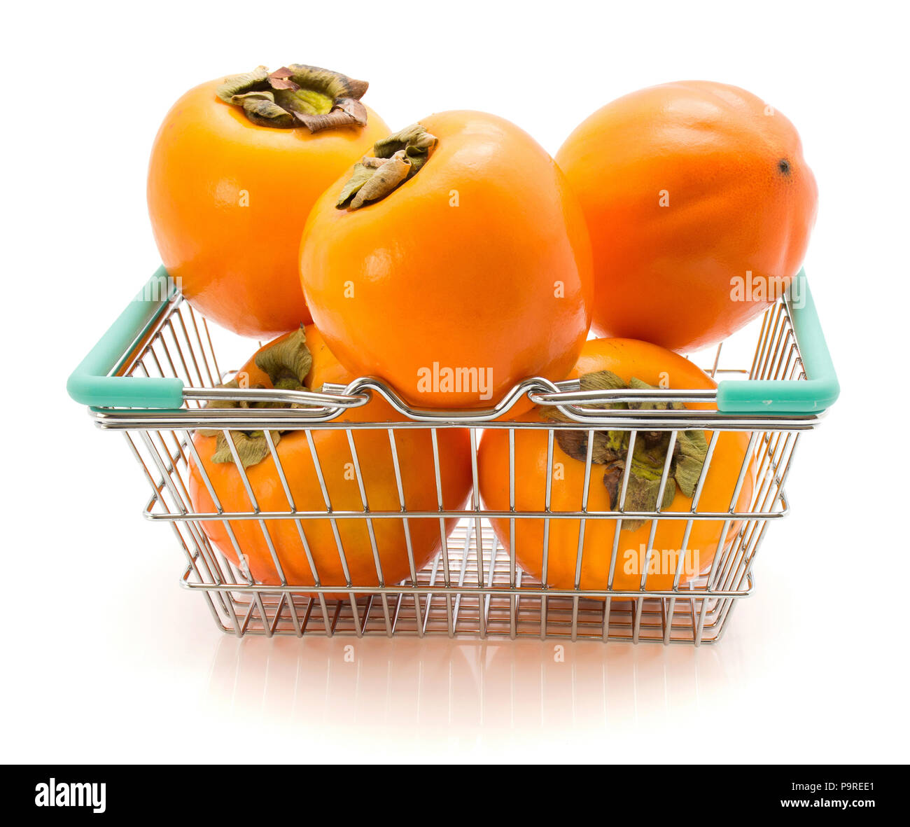 Persimmon Sharon in a shopping basket isolated on white background ...