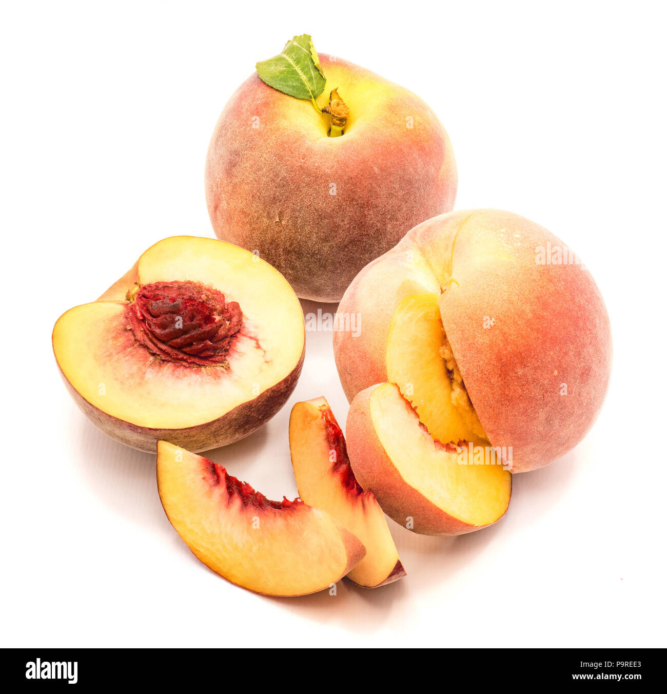Peaches, one whole, one half and cut open, three slices, isolated on ...