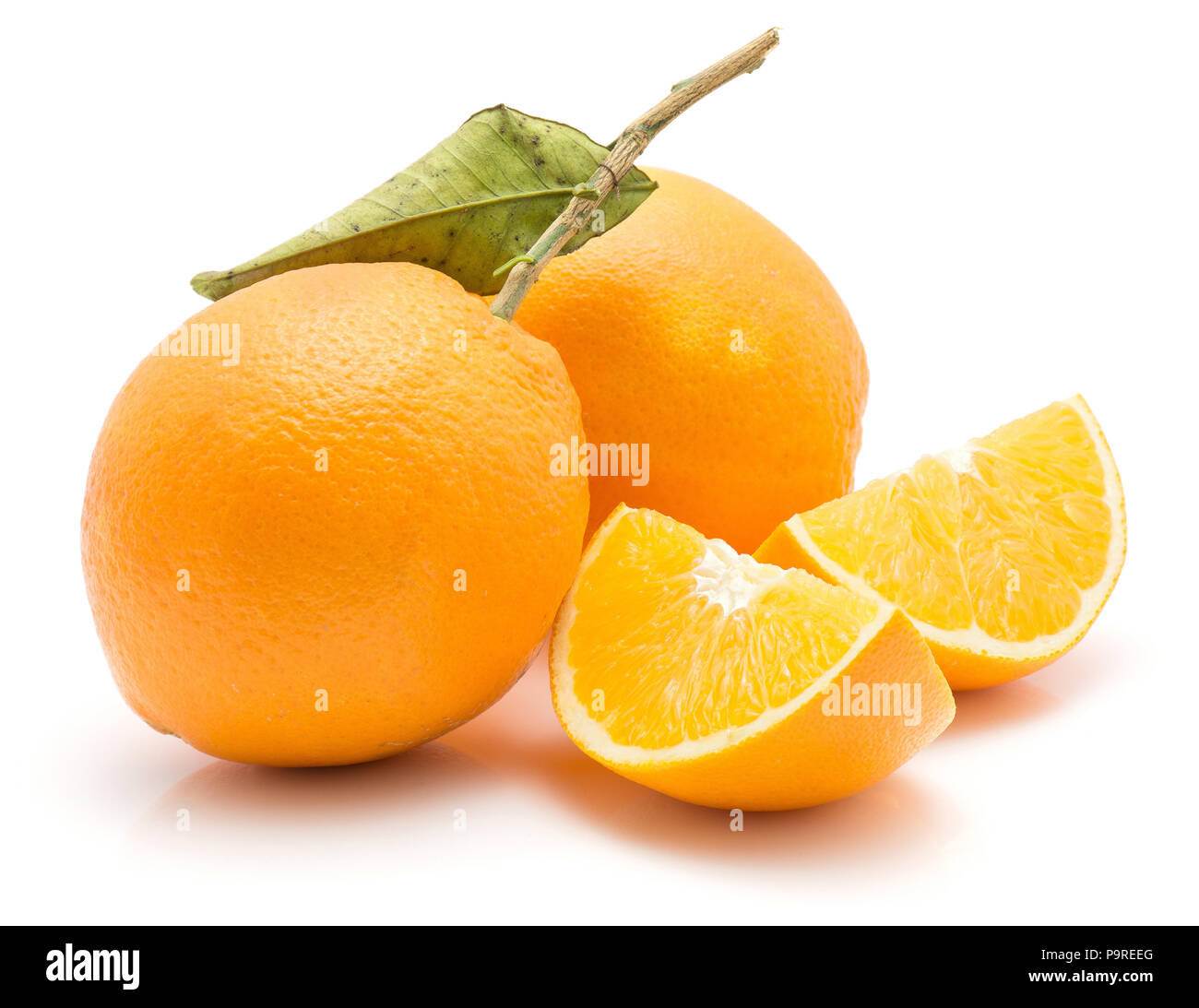 Two oranges and two quarters isolated on white background one with ...