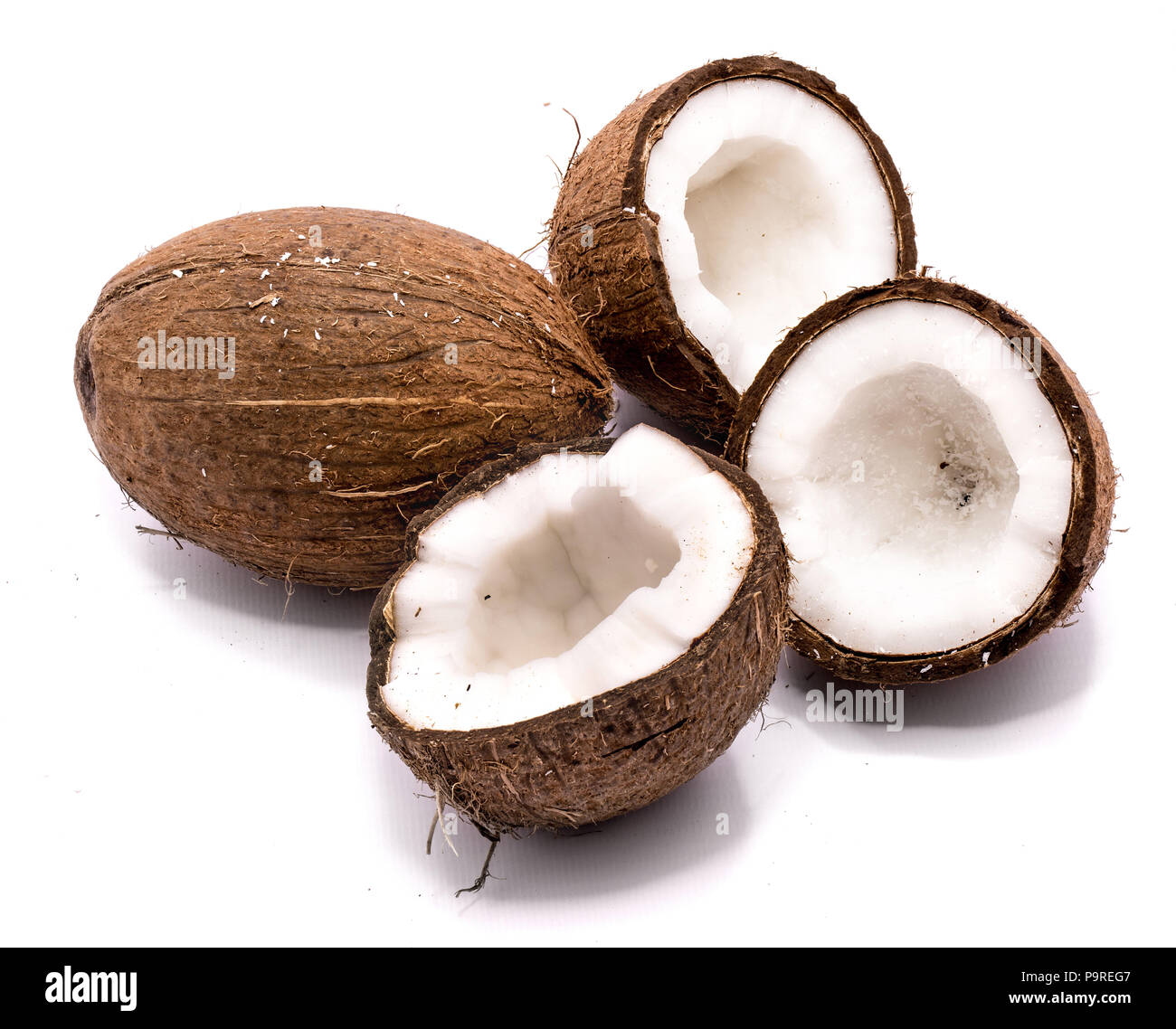 One whole coconut and three halves isolated on white background Stock ...