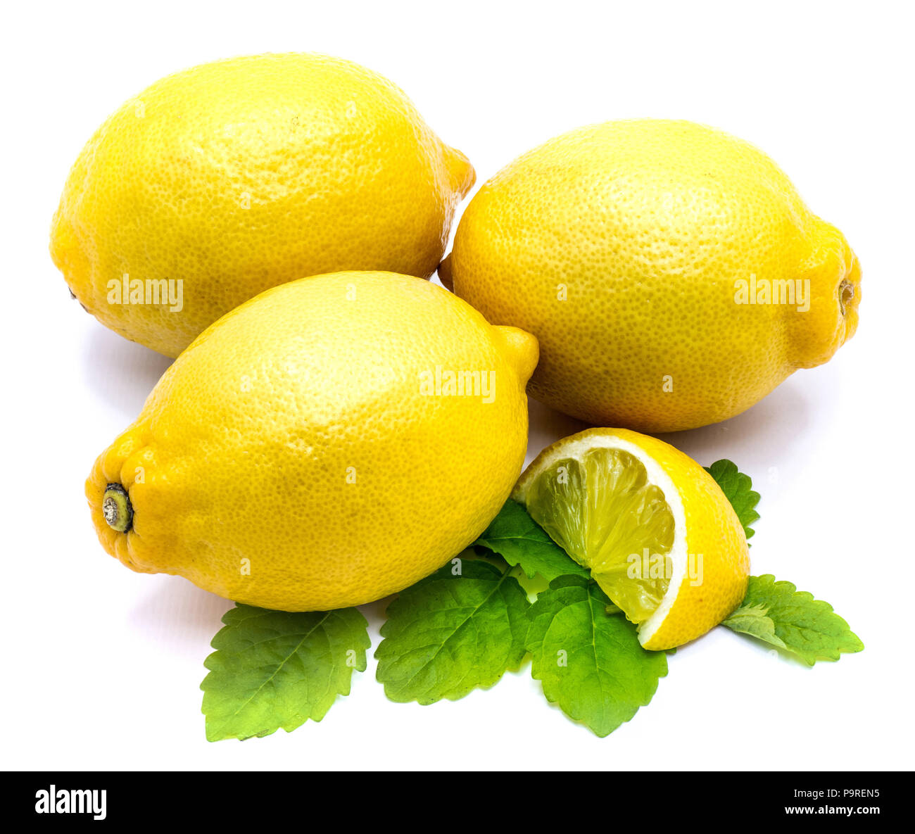 Group of whole yellow lemons, half and slice with fresh lemon balm ...