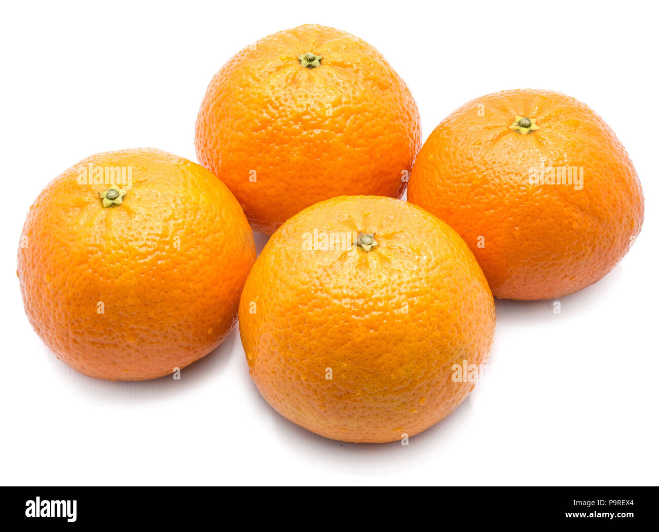 Four whole Clementines with water drops isolated on white background ...