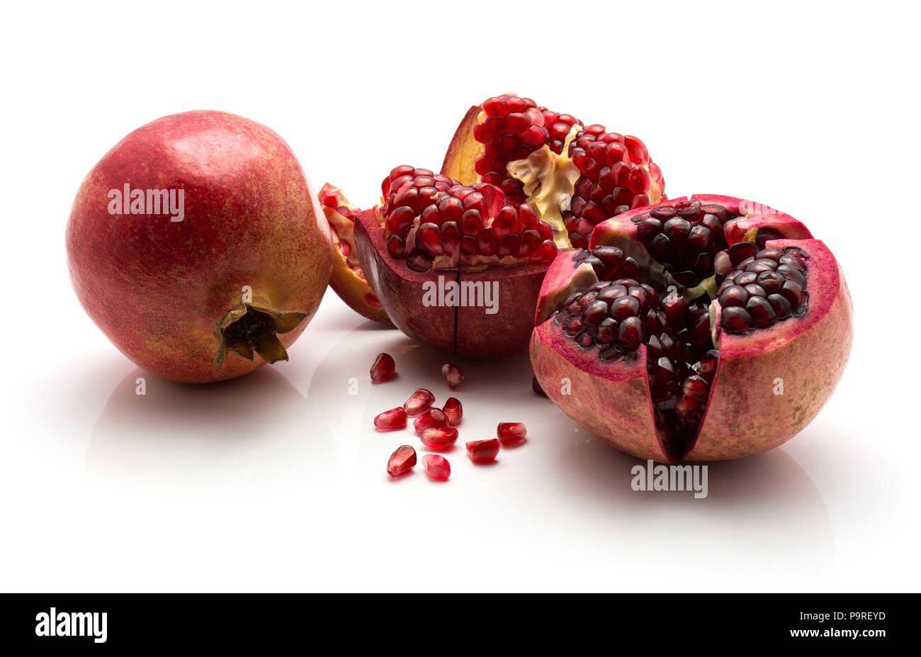 Pomegranate with revealed grains isolated on white background one whole ...