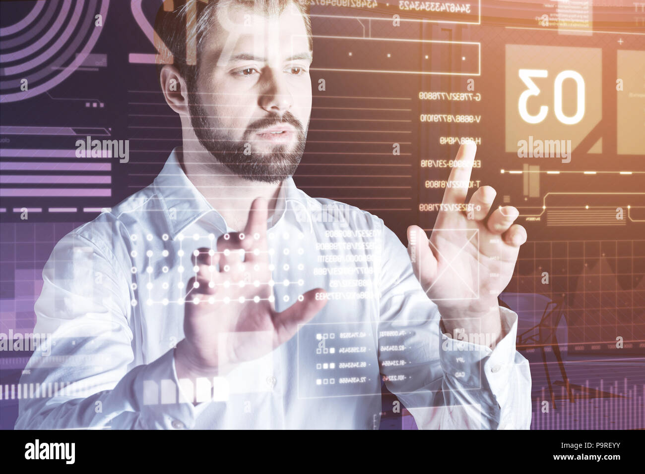 Careful programmer. Professional experienced programmer looking concentrated while being in his ...