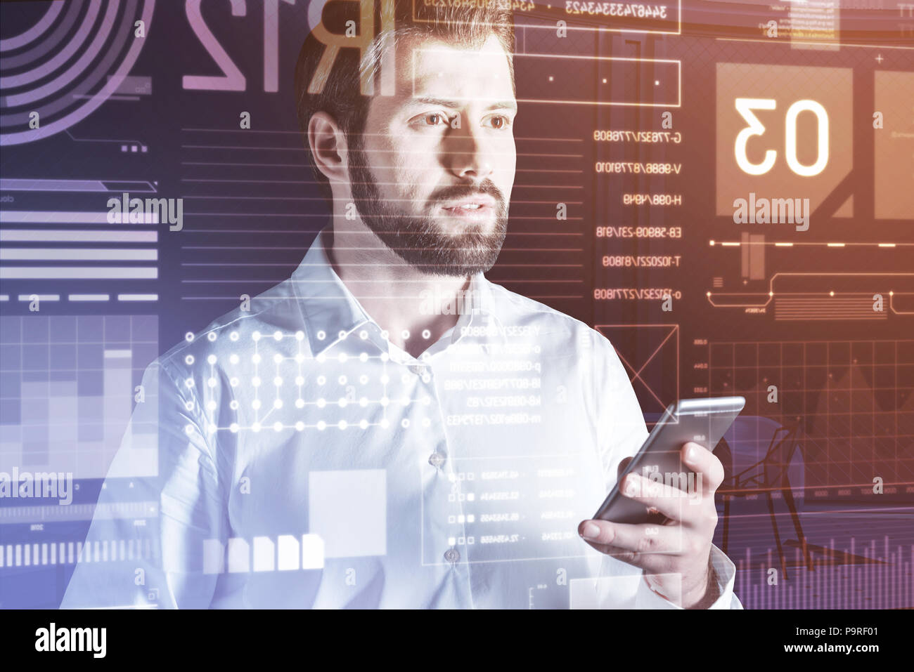 Standing with a smartphone. Calm bearded programmer thoughtfully ...