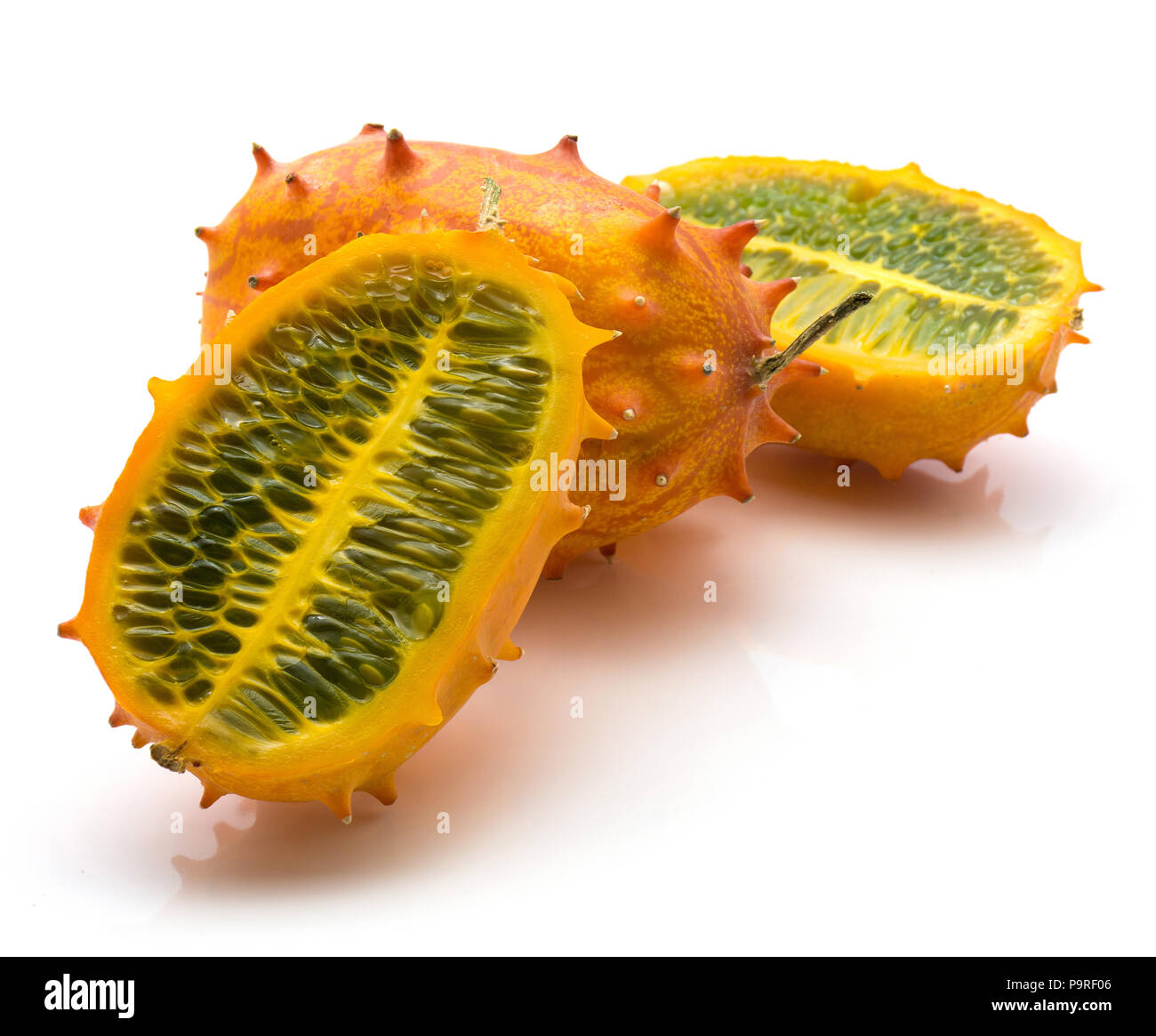 Sliced kiwano isolated on white background one whole and two halves ...