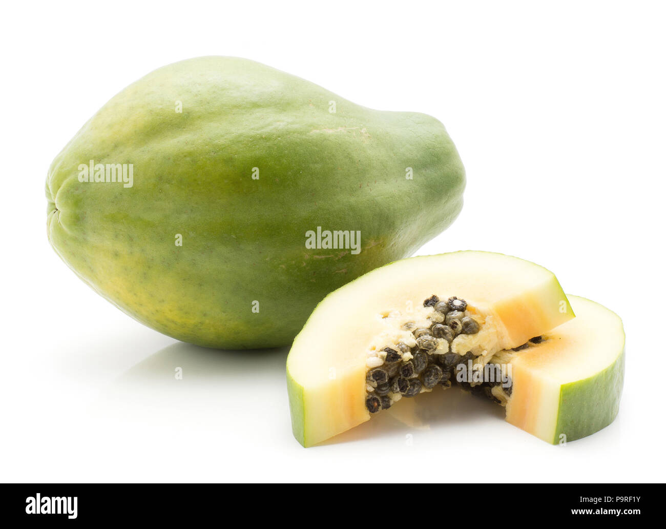 Green papaya (pawpaw, papaw) and two slices isolated on white ...