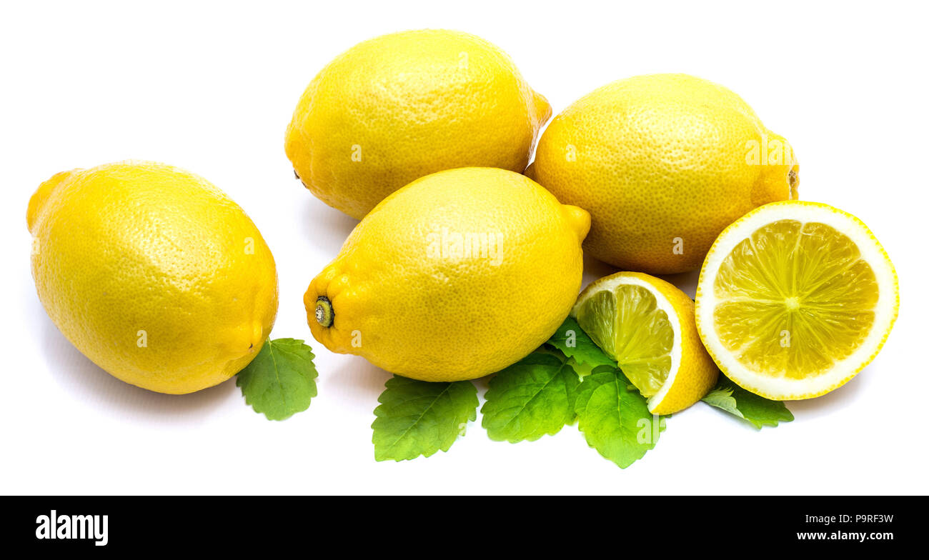 Group of whole yellow lemons, half and slice with fresh lemon balm ...