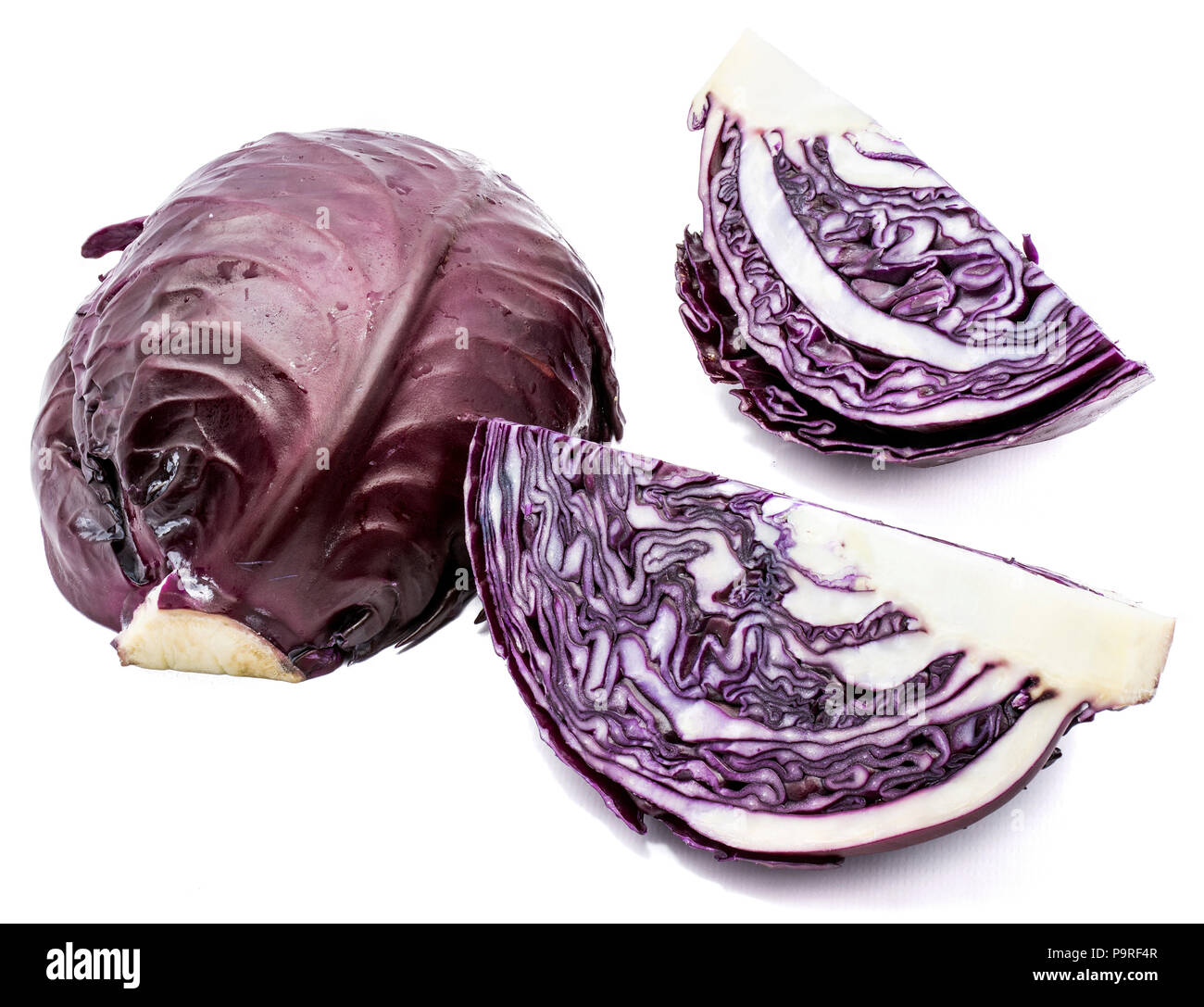 Two sliced quarters of purple cabbage and one half isolated on white ...