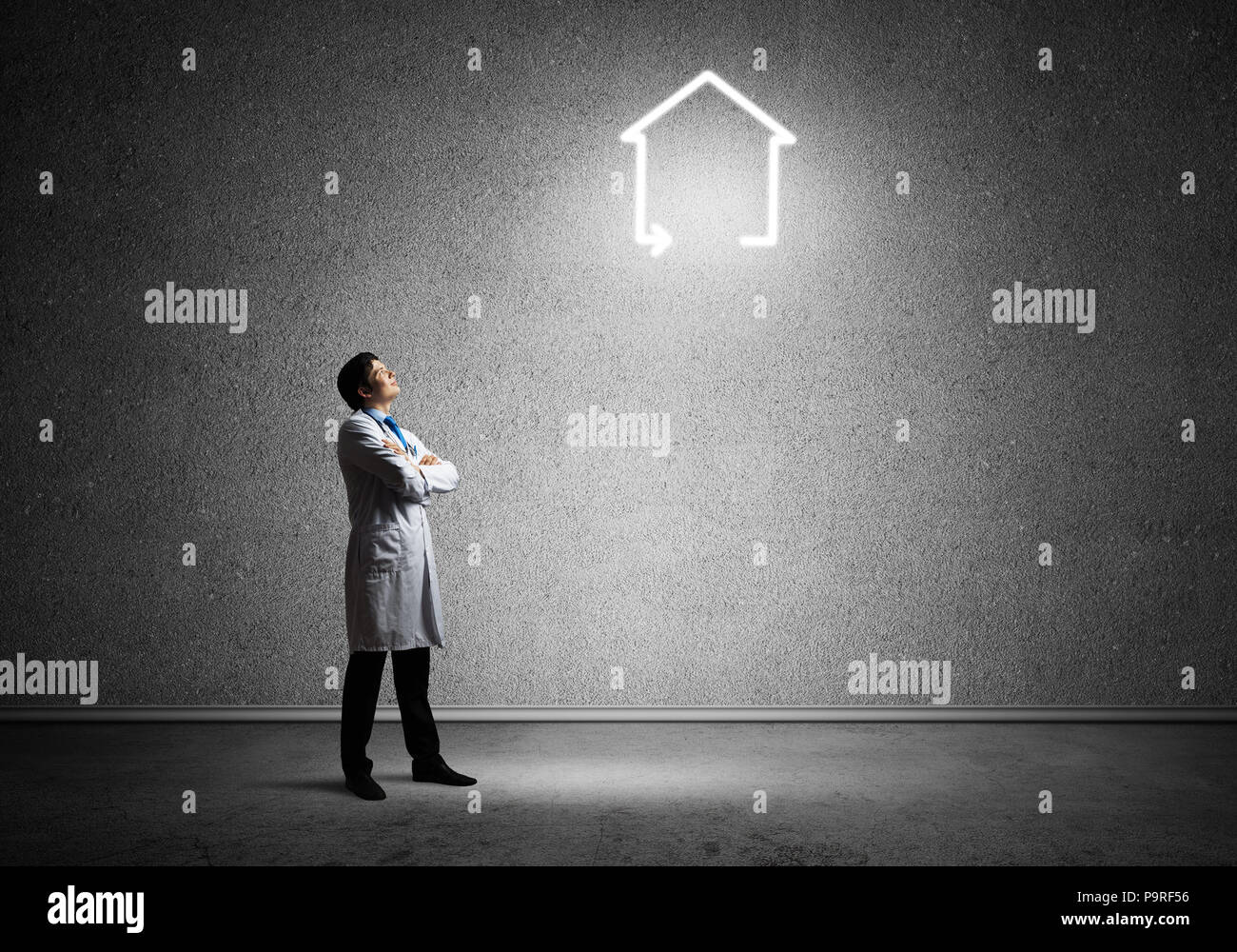 Doctor with house symbol Stock Photo - Alamy