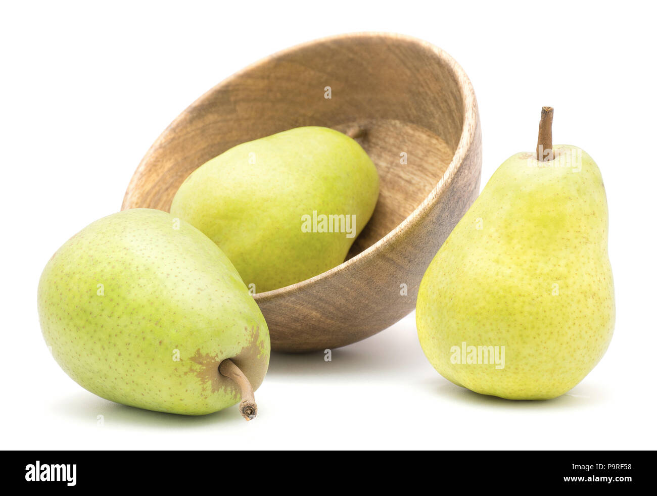 Three green pears in a wooden bowl isolated on white background Stock ...